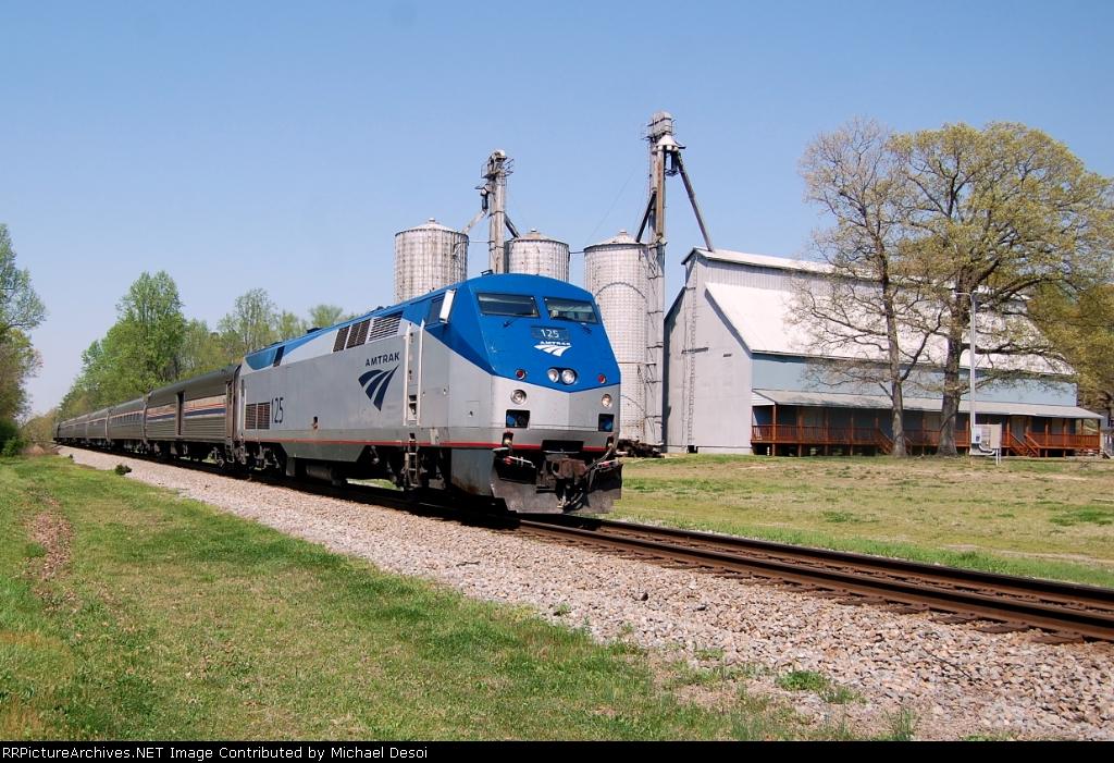 Amtk P-42DC #125 takes a southbound past the old mill